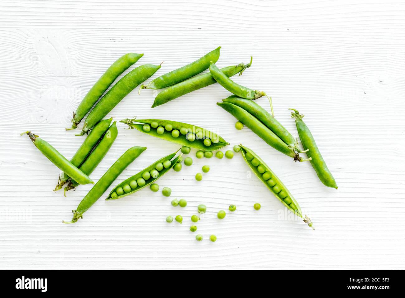 Top view of green pea pods and peas on the kitchen background Stock ...