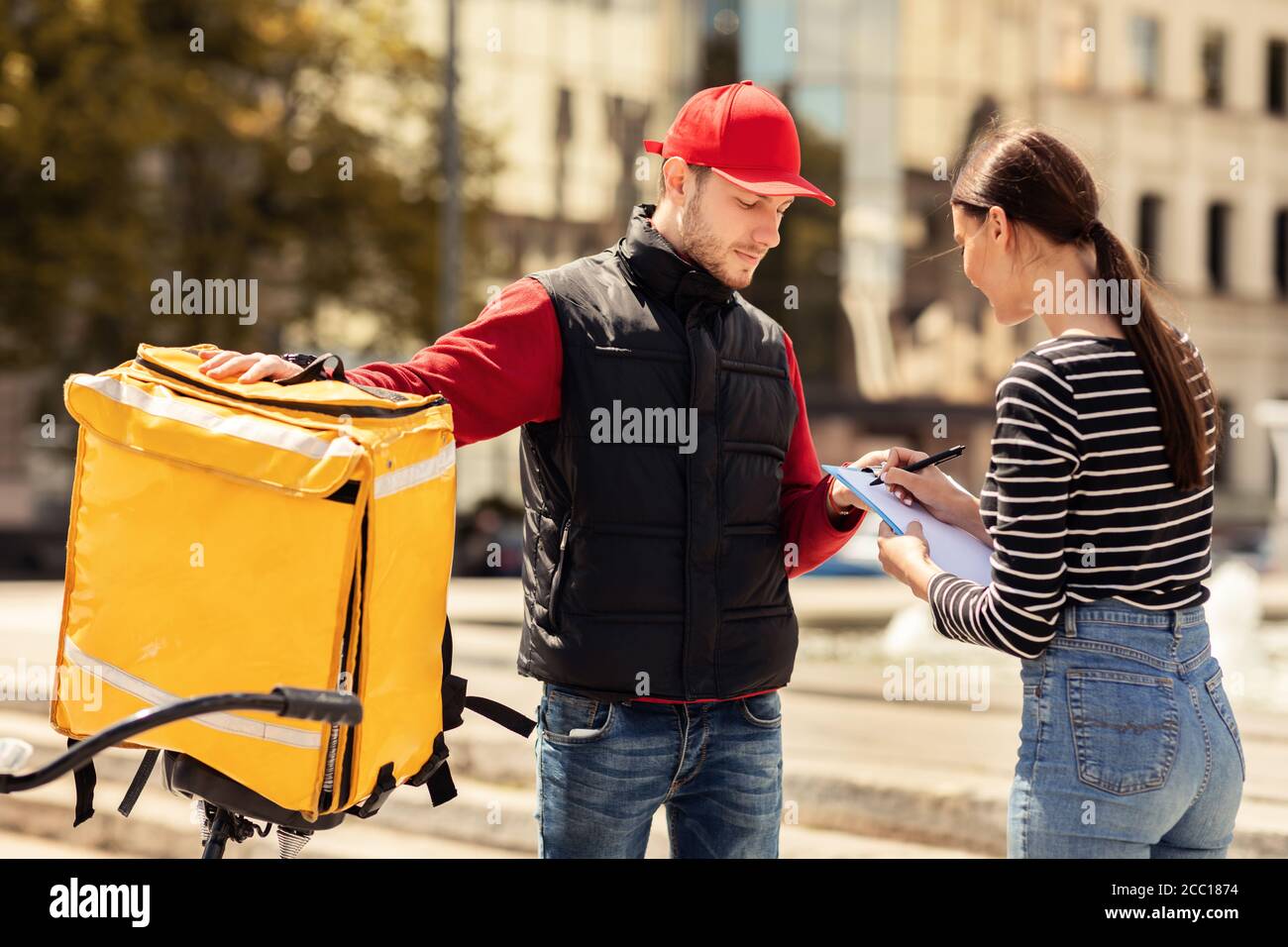 Customer Girl Signing Papers Standing With Delivery Guy Outdoors Stock ...