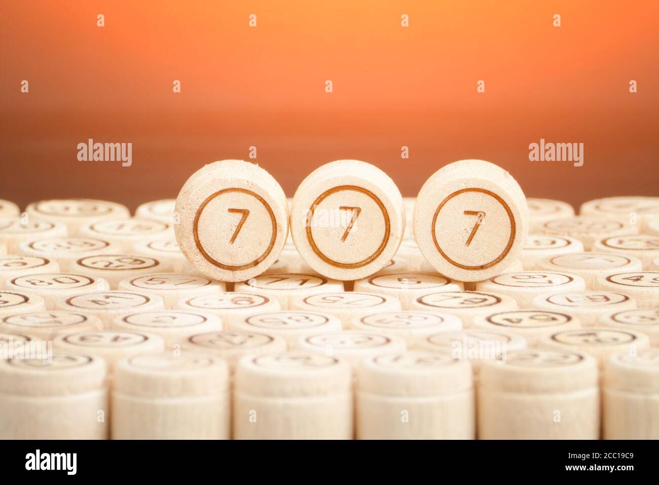 Lucky number 777 on the wooden keg lotto. Black background. Close up ...