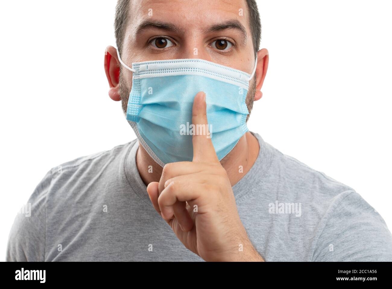 Adult white man making shush silent gesture with index finger over ...