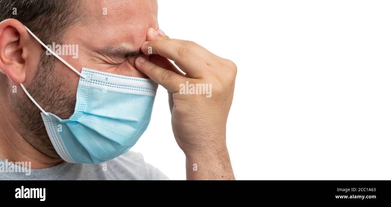 Close-up of thinking adult man touching forehead using fingers as ...