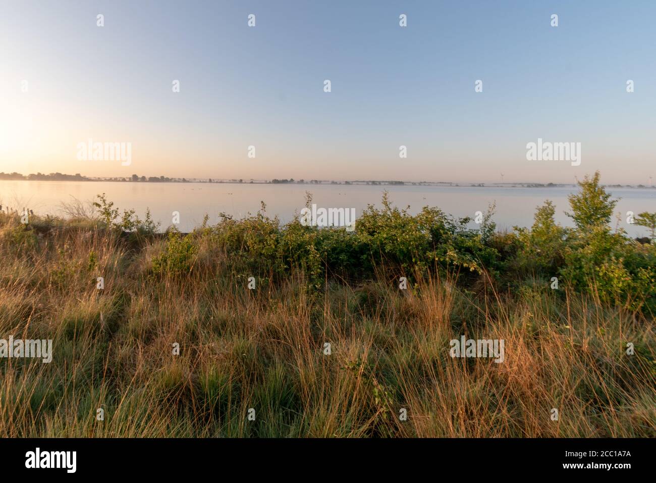Low angle shot of a river and grassland Stock Photo - Alamy