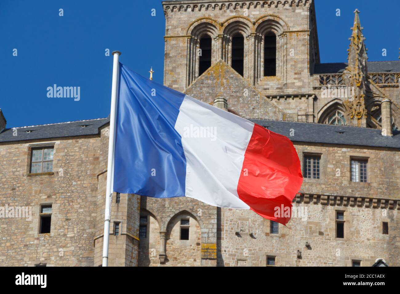 French flag waving at the top of a pole Stock Photo - Alamy