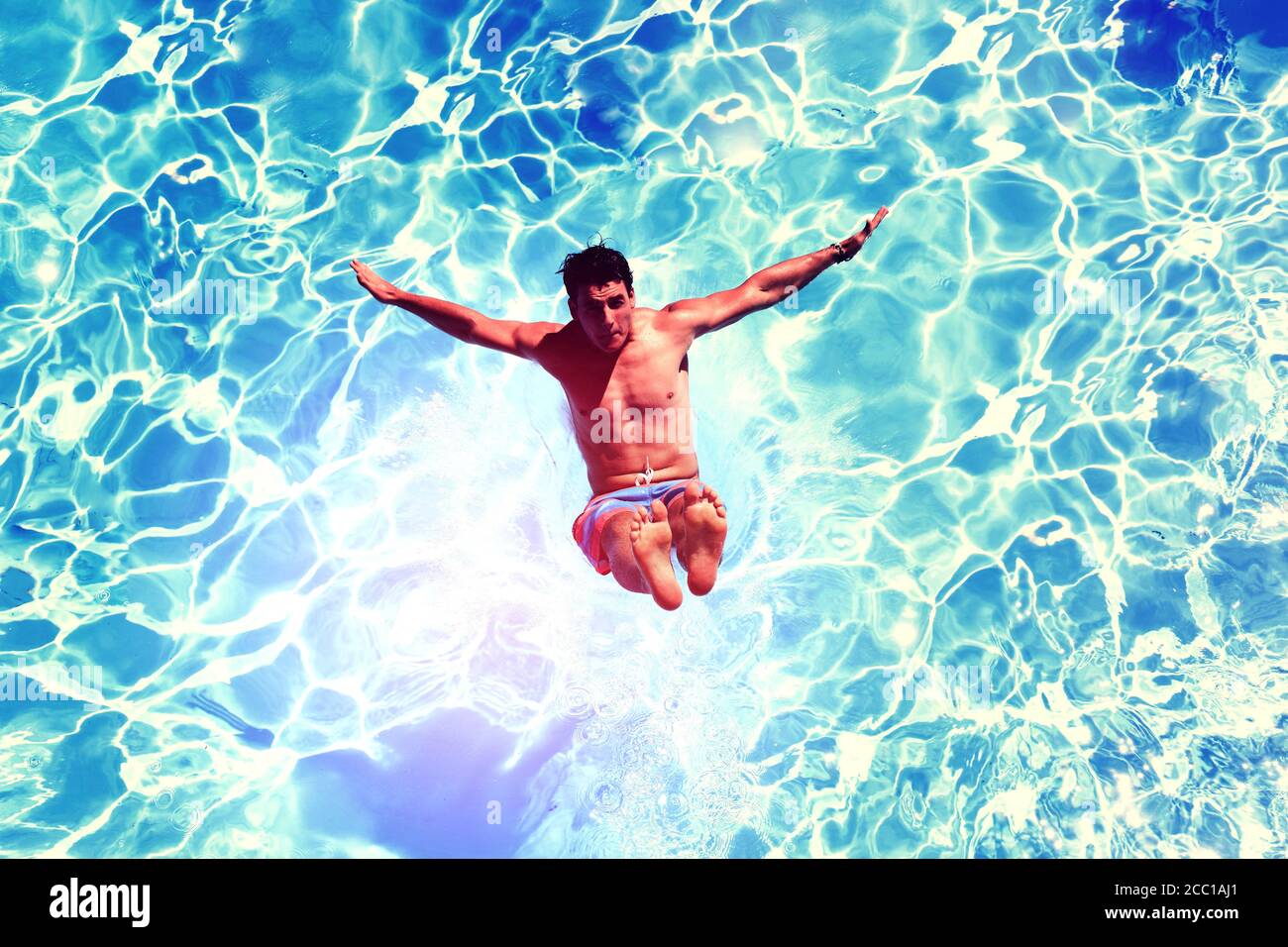 Young man falling into a swimming pool Stock Photo - Alamy