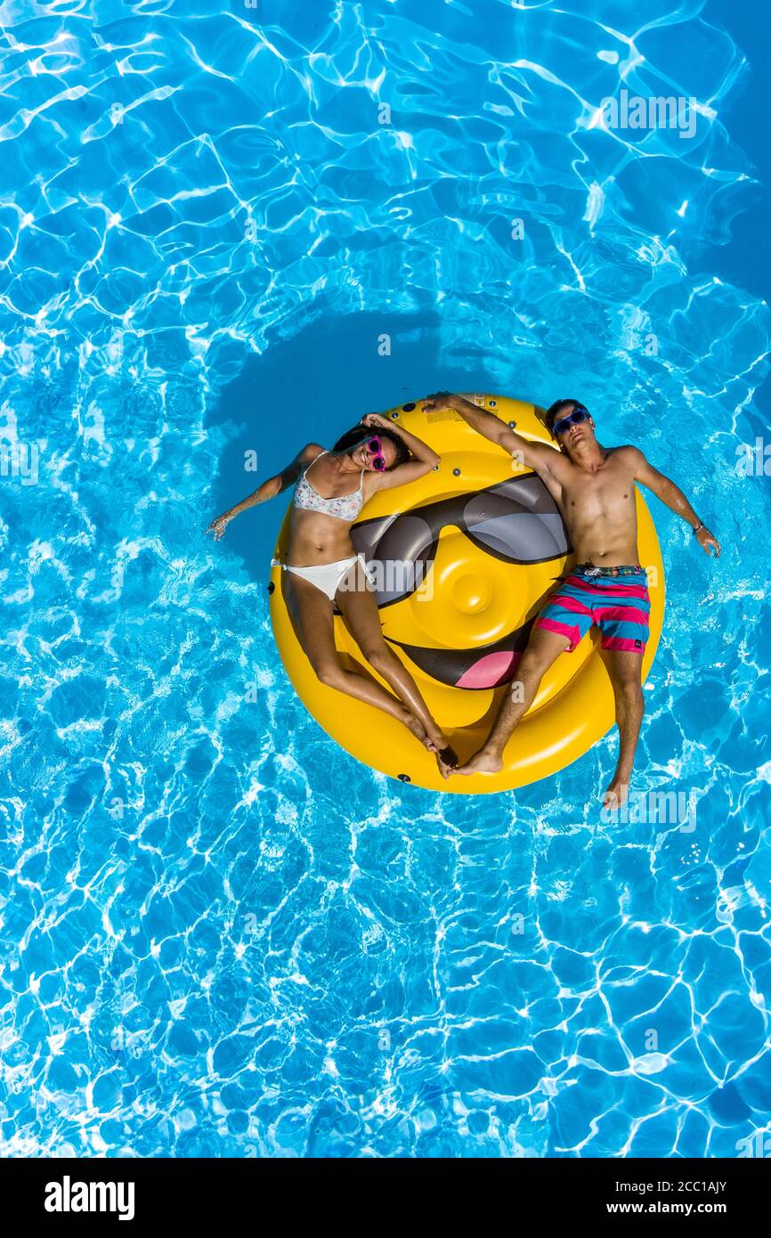 Young couple and smiley buoy at the pool Stock Photo - Alamy
