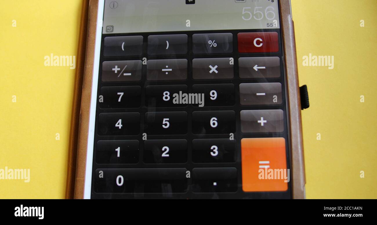 Finger Types numbers on calculator and adds them up Stock Photo - Alamy