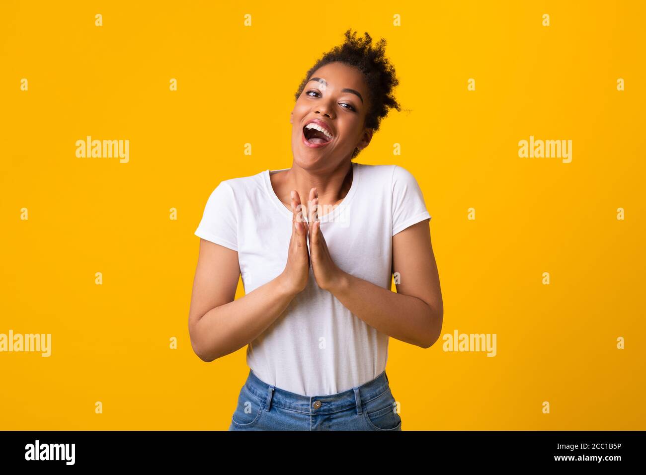 Happy young girl raising hands up at studio Stock Photo - Alamy
