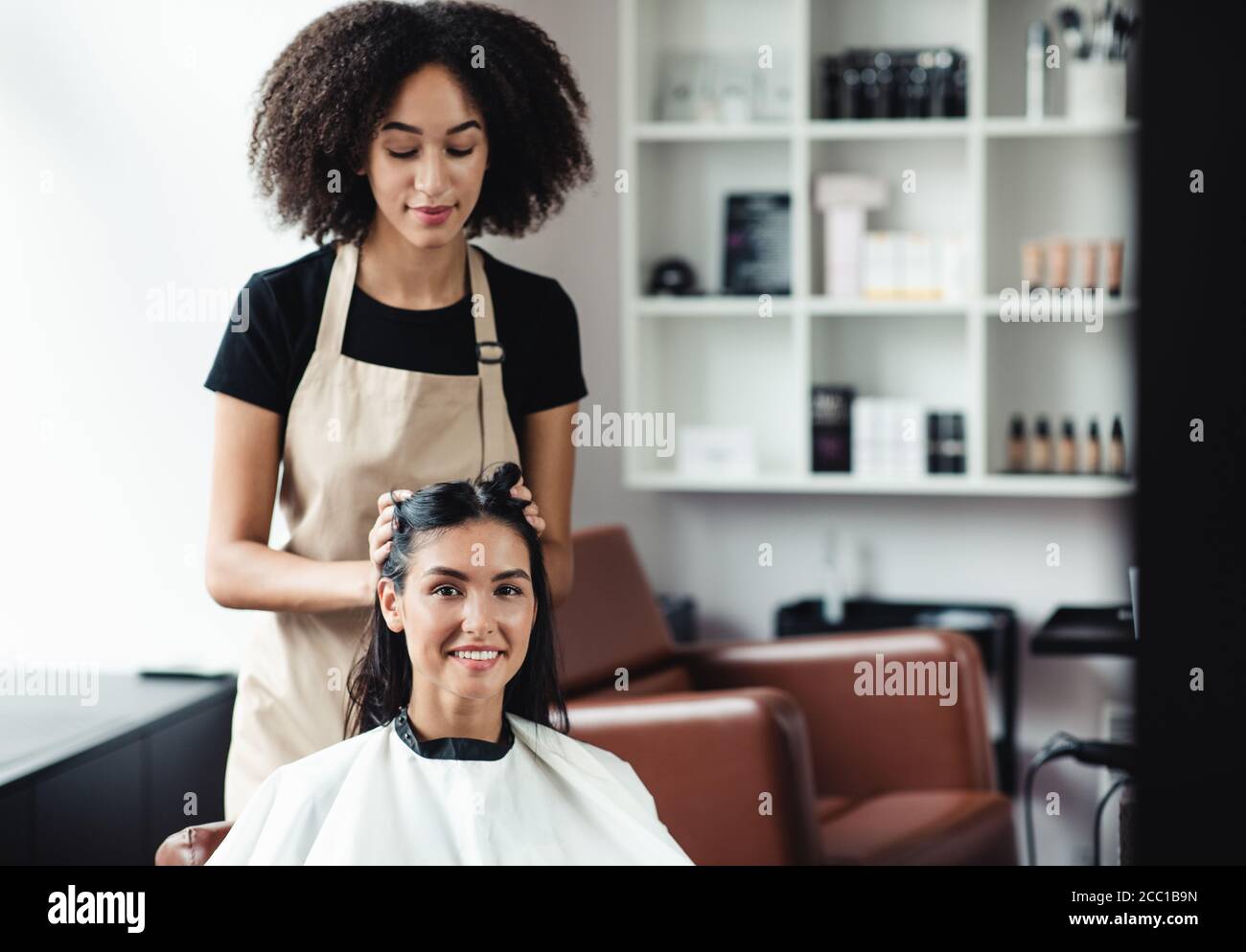 Beauty master making new hairstyle for young woman Stock Photo - Alamy