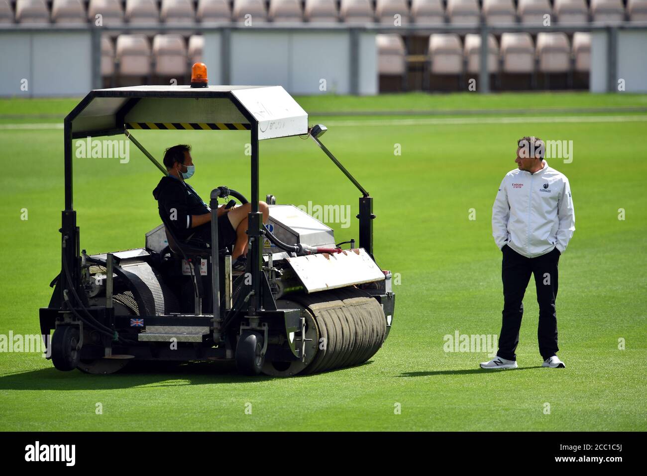 Umpires Richard Kettleborough speaks to the ground staff as they ...