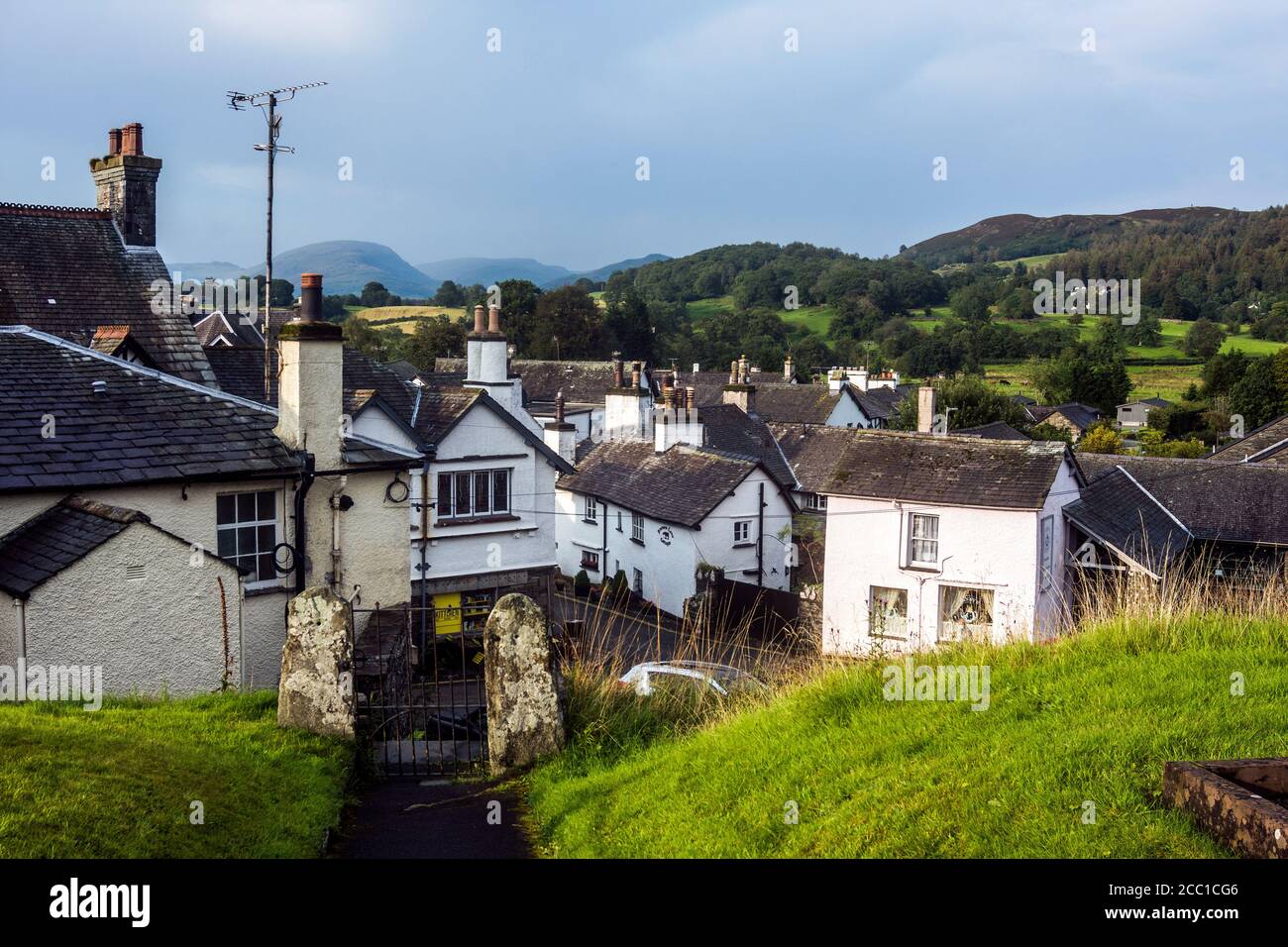 The village of Hawkshead and fells beyond Stock Photo - Alamy