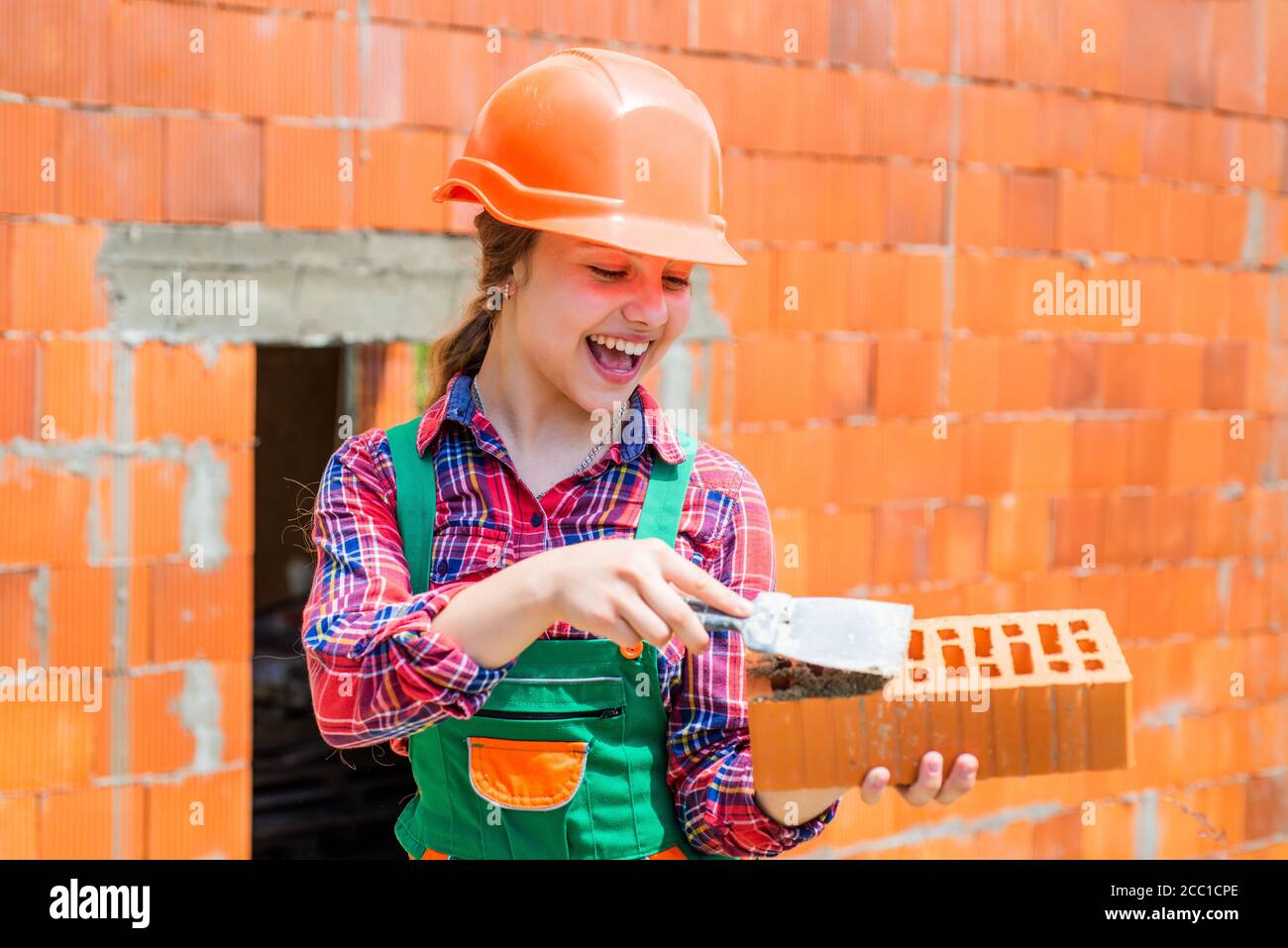 lay bricks. engineer teen is construction worker. Professional ...
