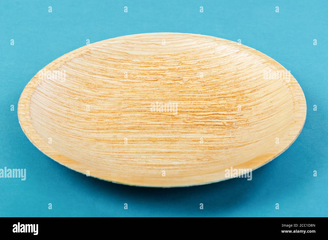 Plate from dried betel nut leaf palm, natural material on blue ...