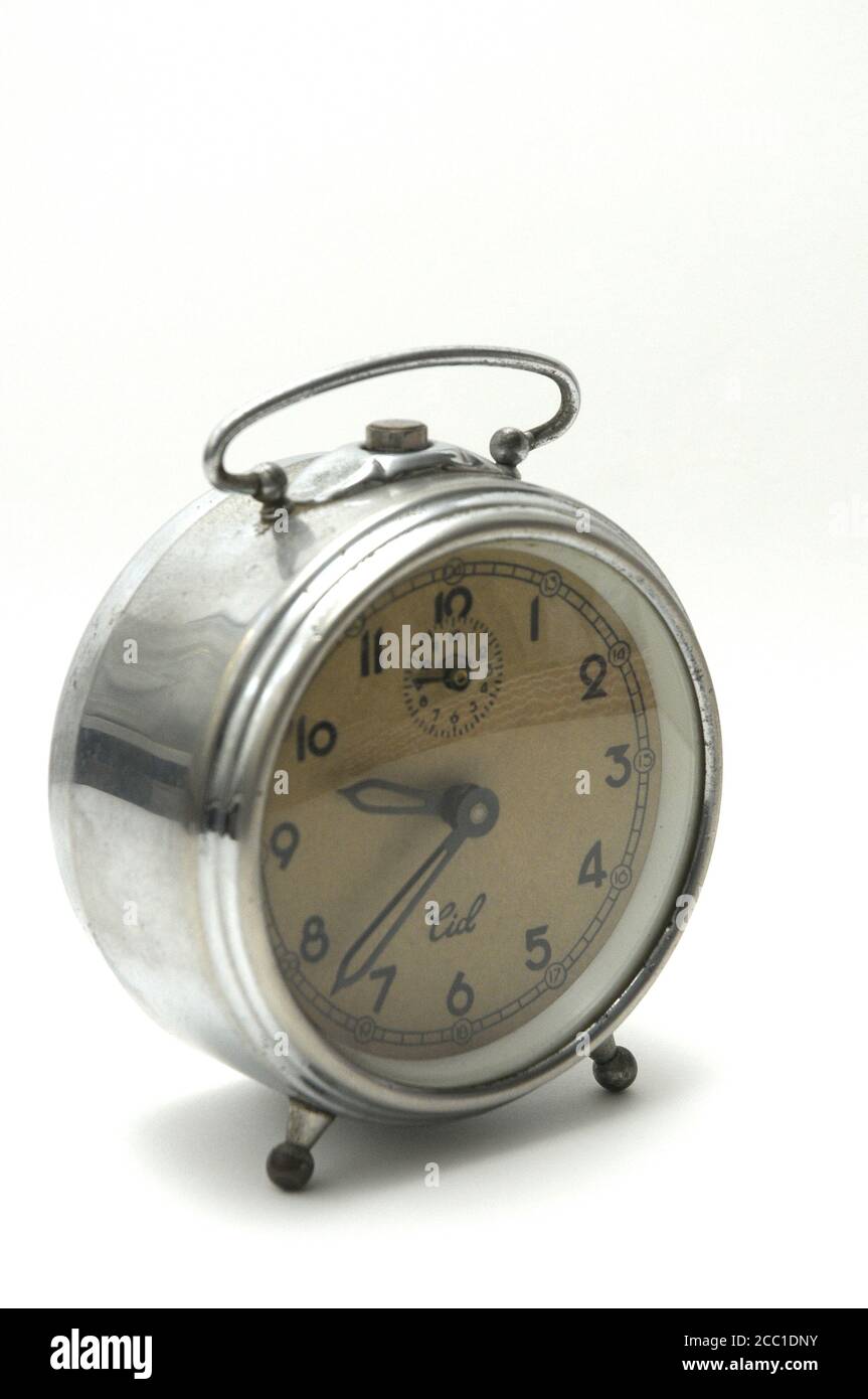 vintage alarm clock showing almost twenty to ten Stock Photo - Alamy