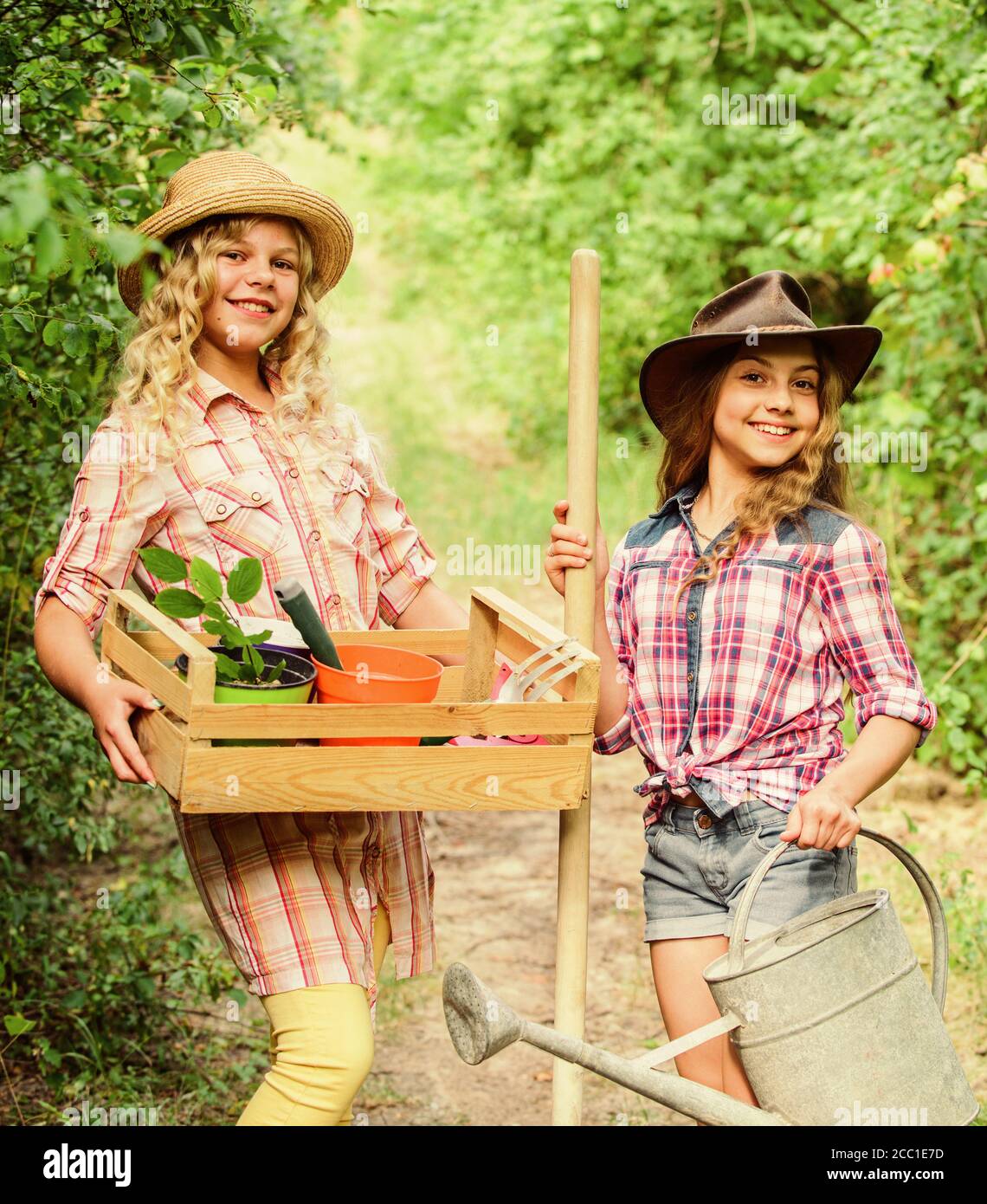 Working with plants. happy children hold gardening tools. farming and ...