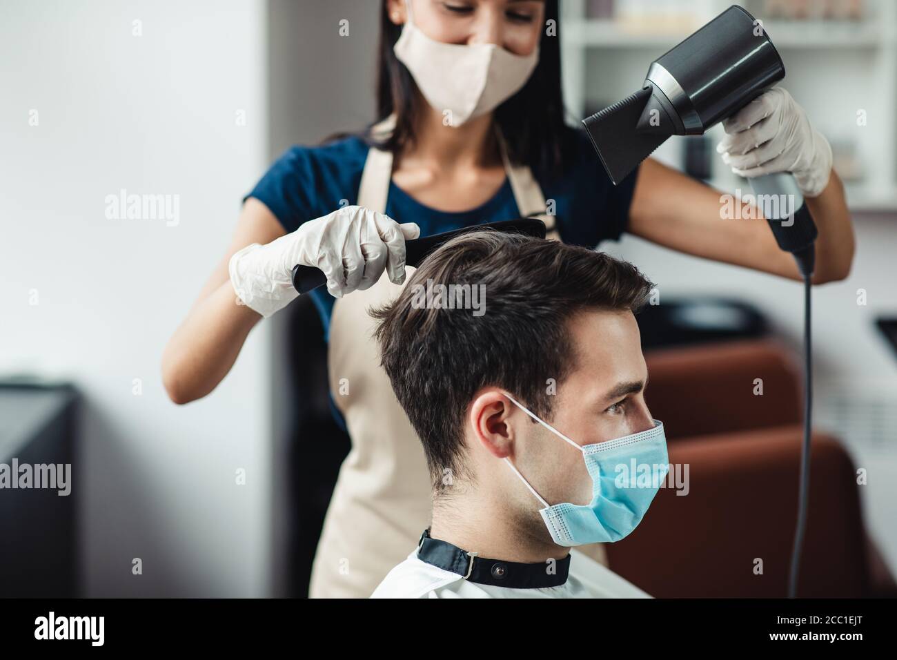 Young guy getting hairdo at salon, close up Stock Photo - Alamy