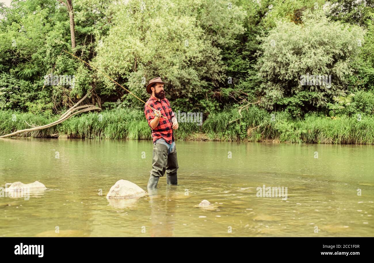 River lake lagoon pond. Trout farm. Fisherman alone stand in river ...