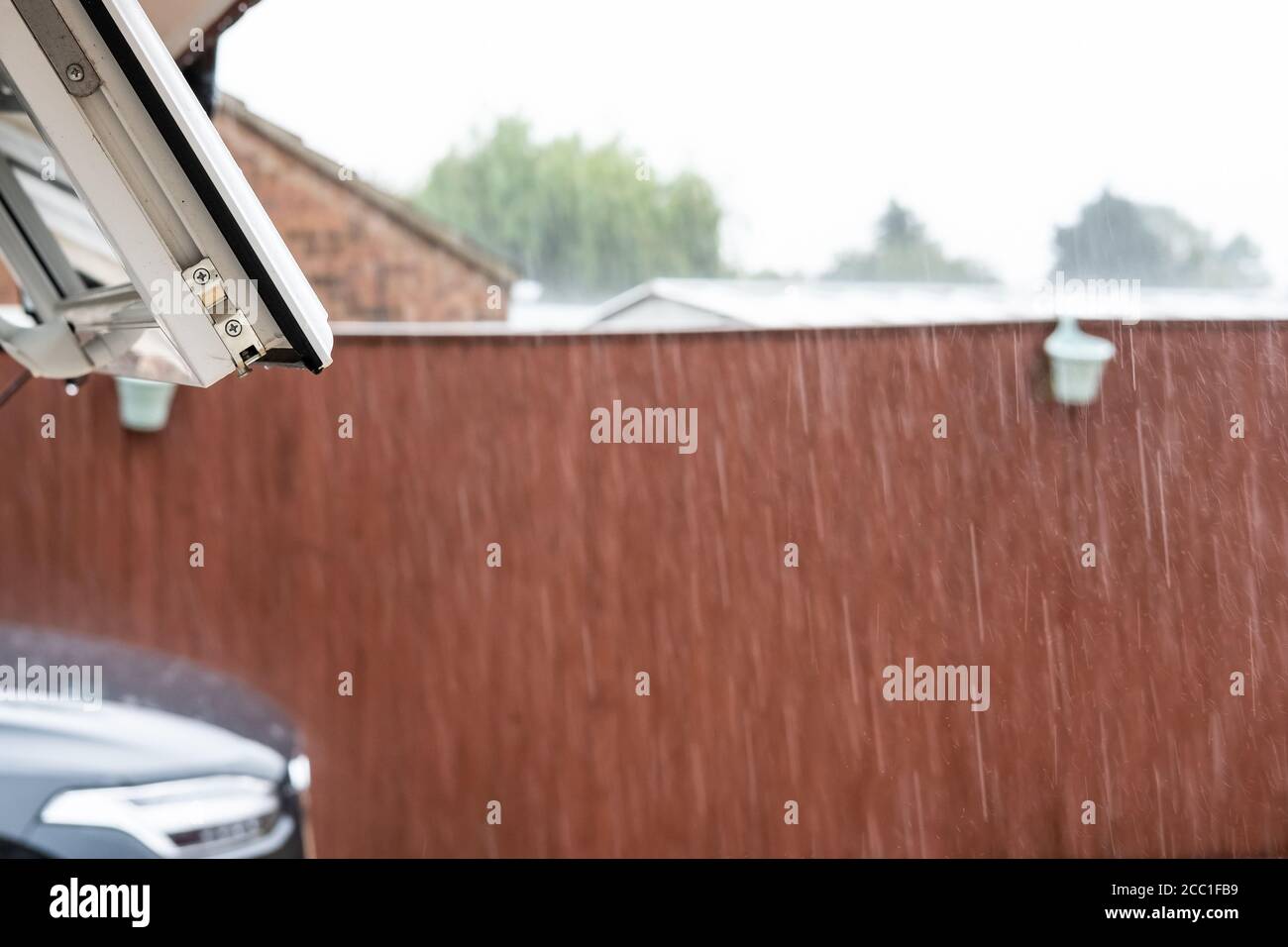 Shallow focus of an opened uPVC window seen at the rear of a house ...