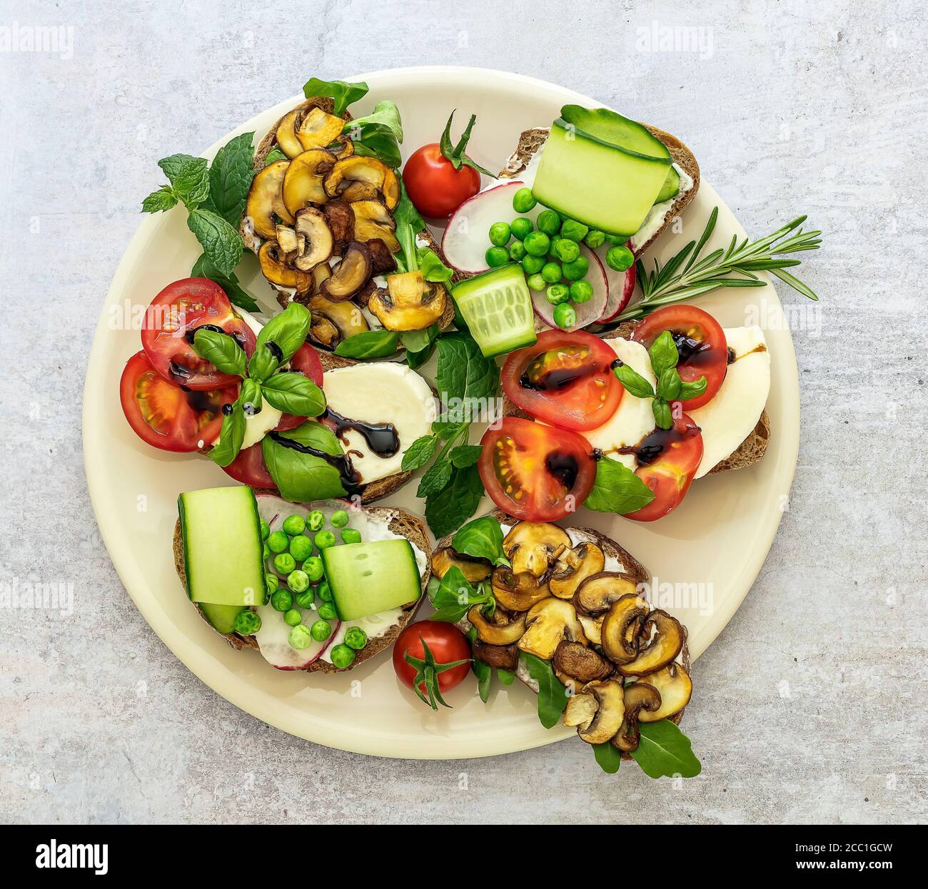 Plate with vegetarian sandwich toasts with different toppings, top view ...