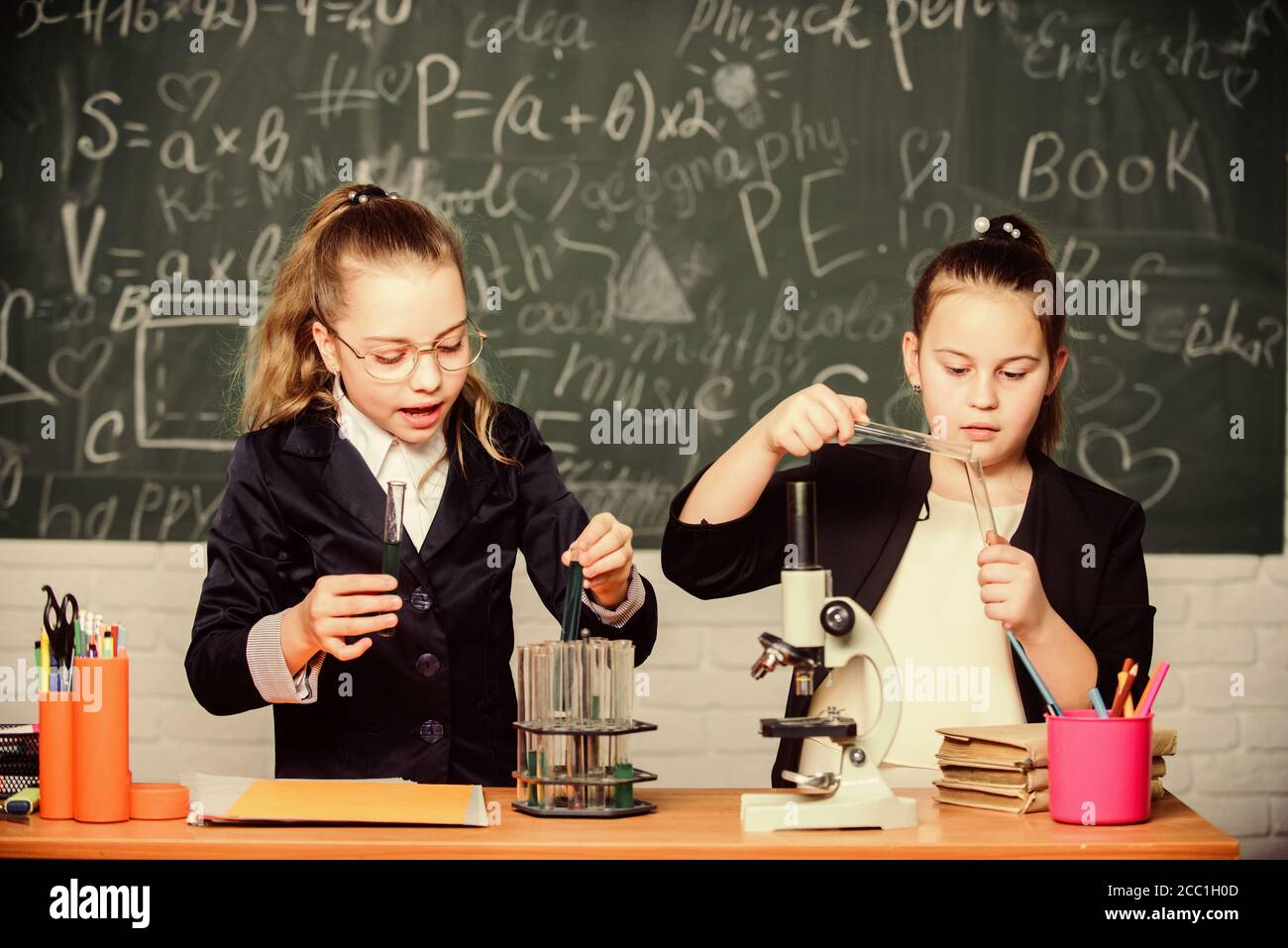 For a better tomorrow. Little girls genius in school lab. Science lab ...