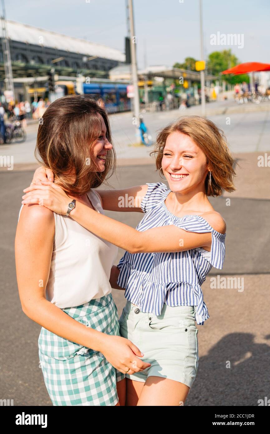 Portrait of two girls friends hugging each other Stock Photo - Alamy