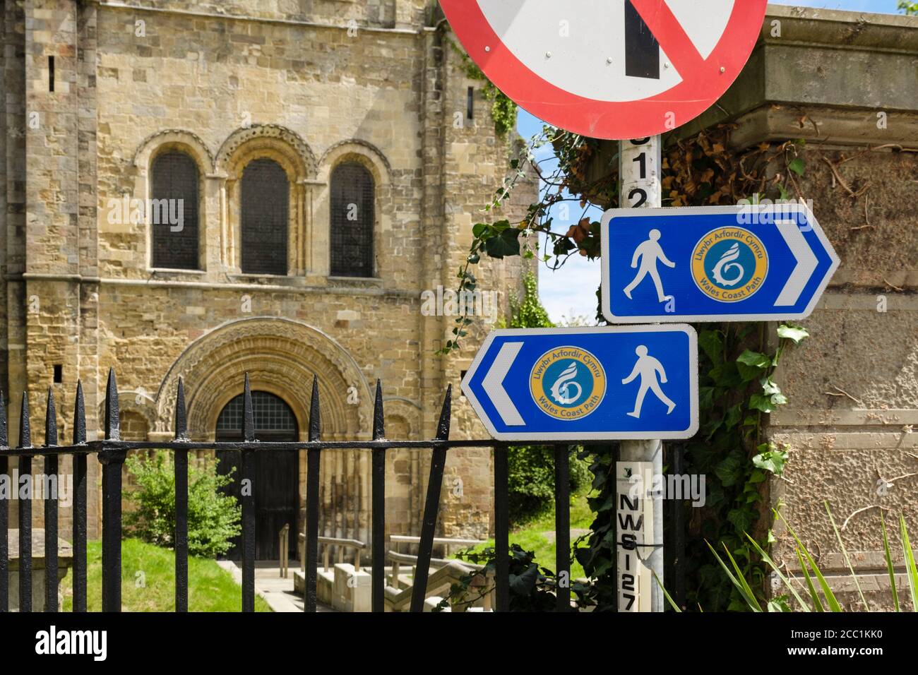 Bilingual Wales Coast Path direction signs both directions outside St ...