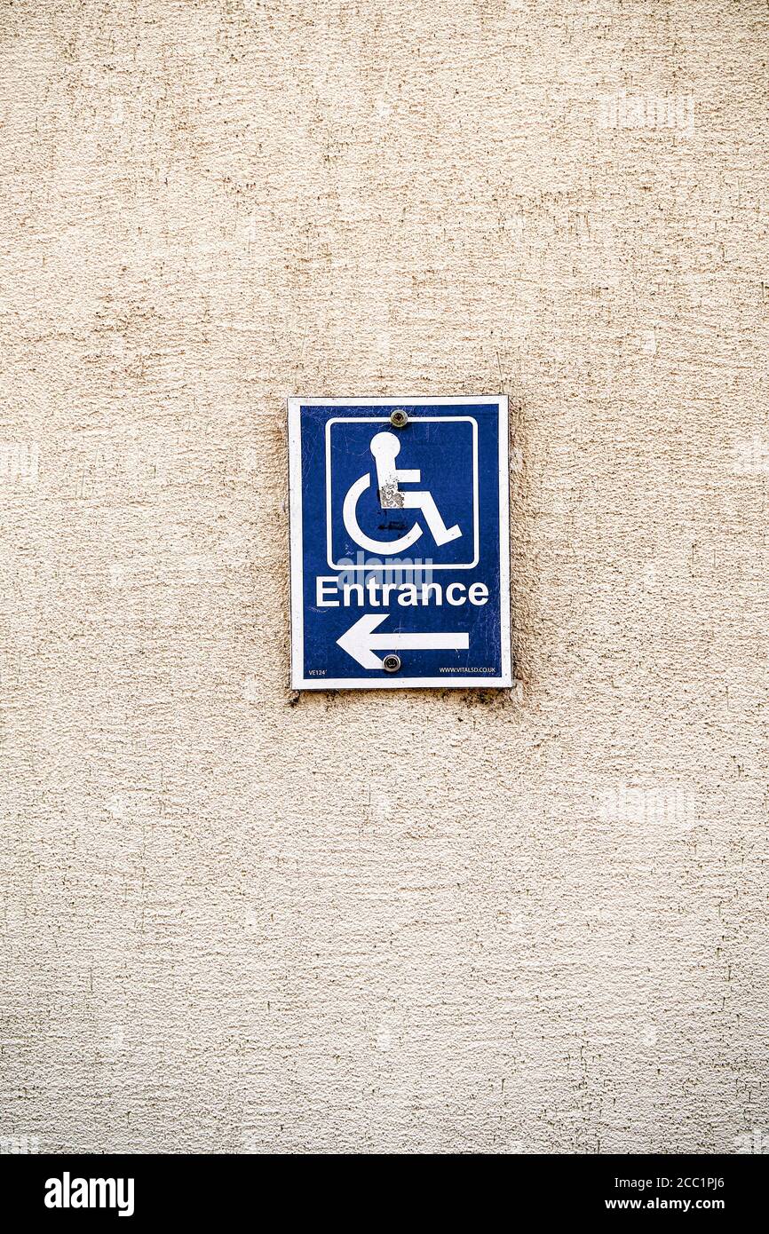 Disabled persons entrance sign on white wall with copy space Stock ...