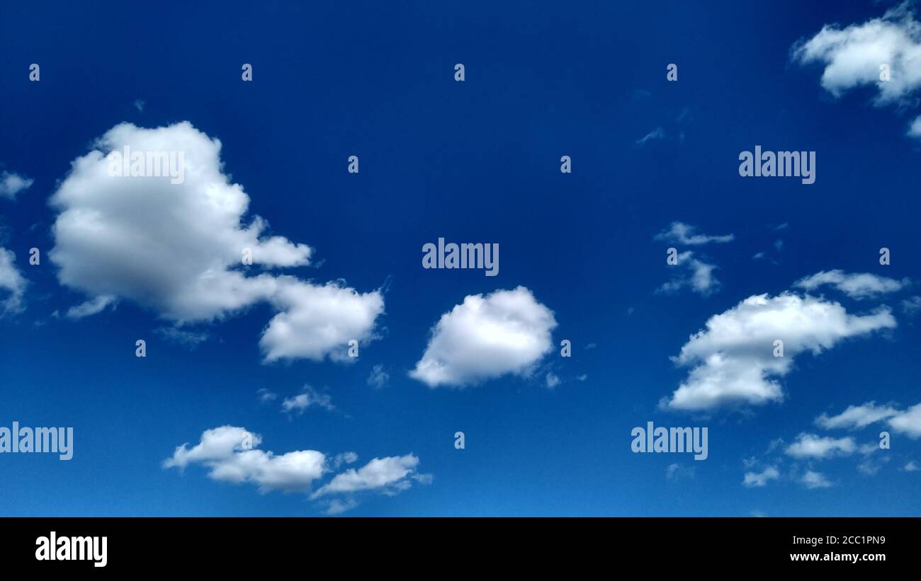 Blue sky with white clouds. Peaceful sky background. Space for text ...