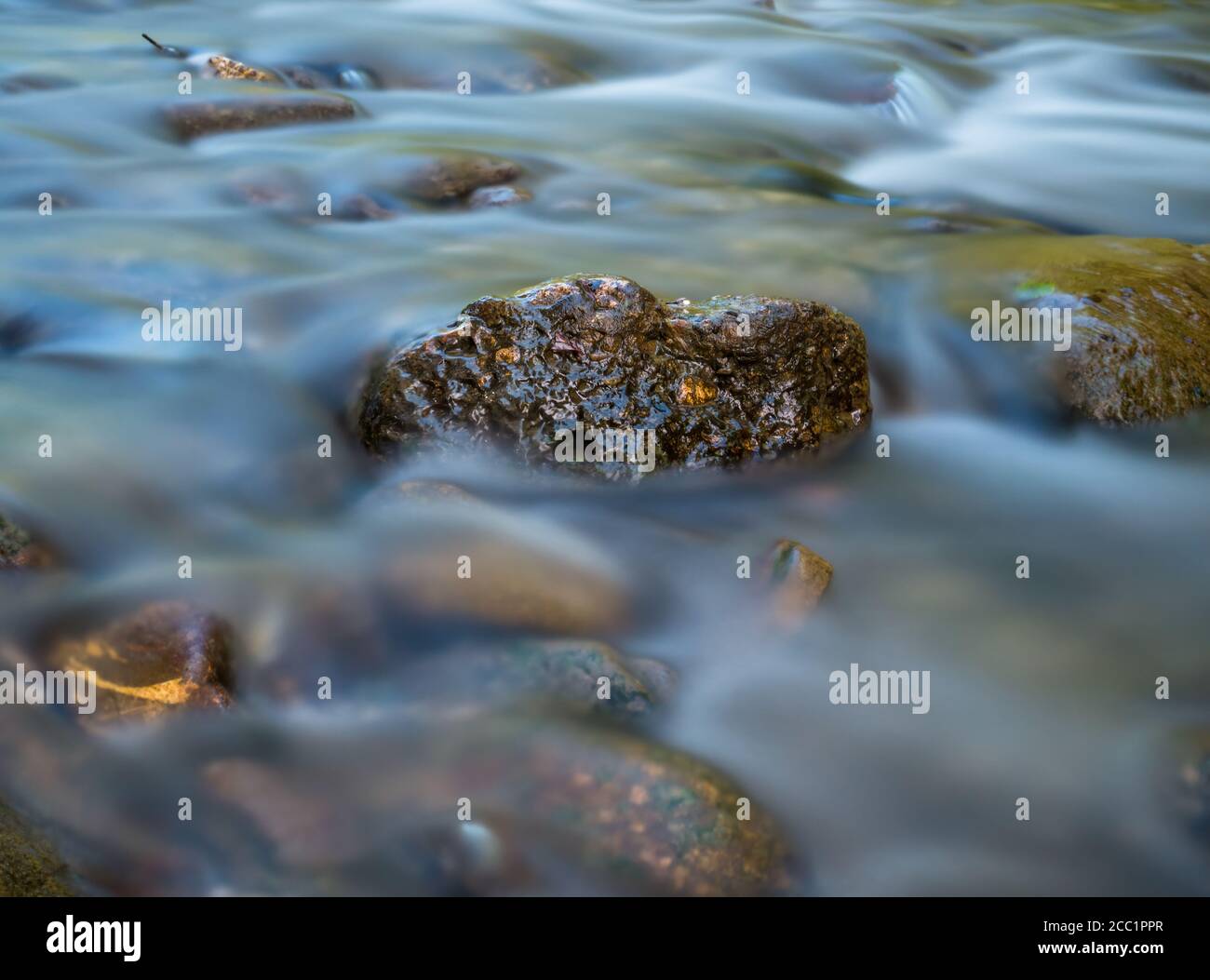 Long exposure picture of water stream flowing. Smooth water background ...