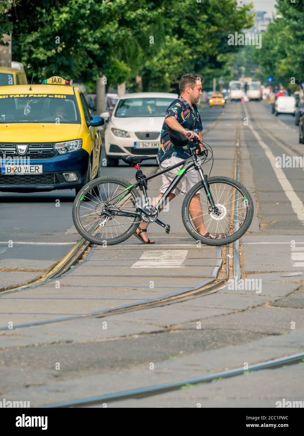 Man walking the bike across the street as a pedestrian. Man with his ...