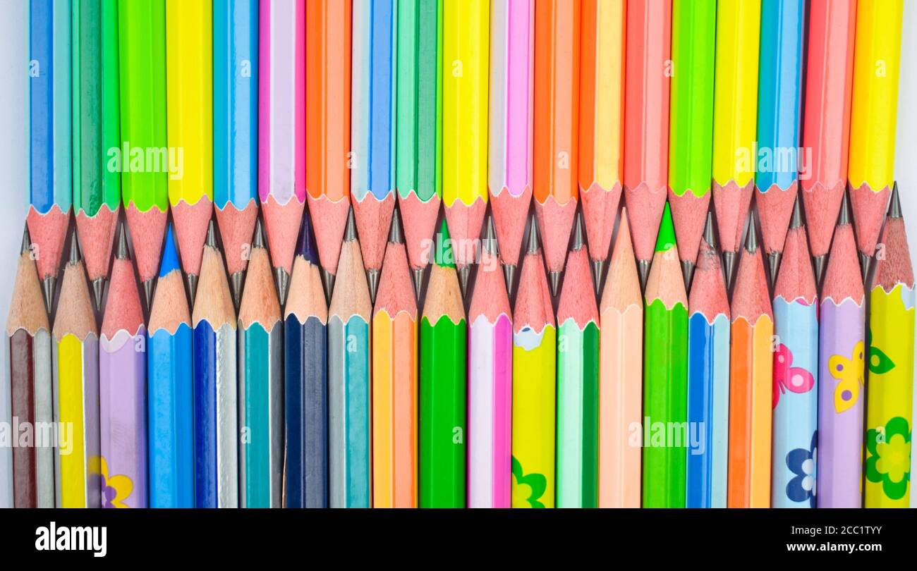 Attached row of many different colored wood pencil crayons with ...
