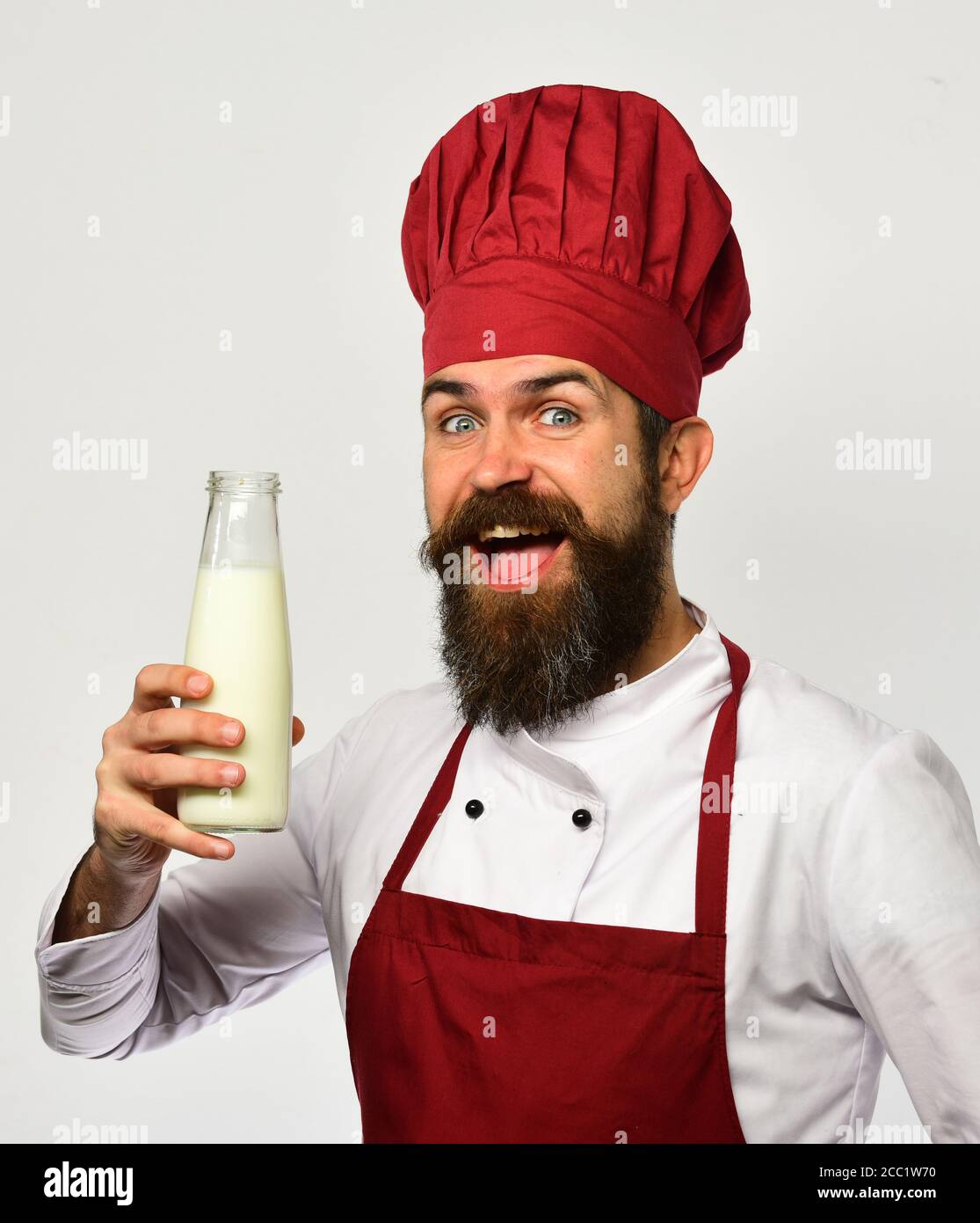 Chef with milkshake or yoghurt. Cook with surprised face in burgundy ...
