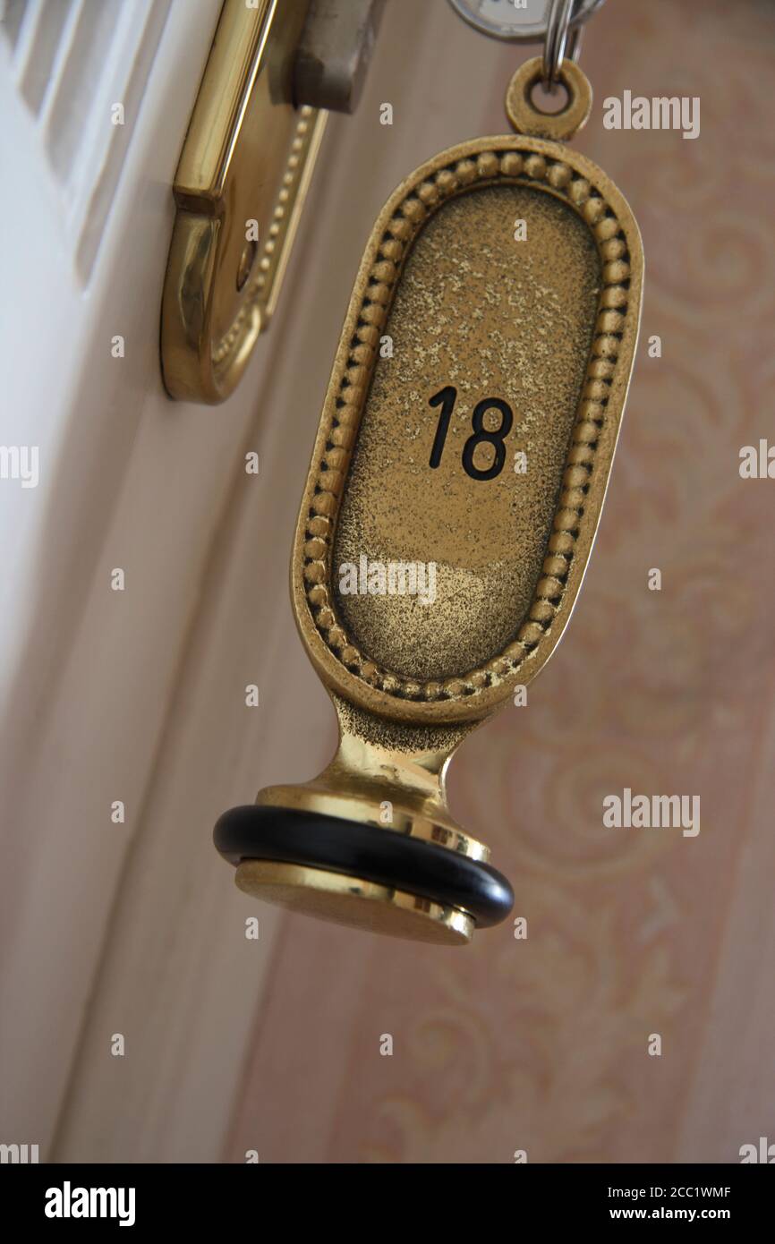 Hotel key in a room door, close-up Stock Photo - Alamy