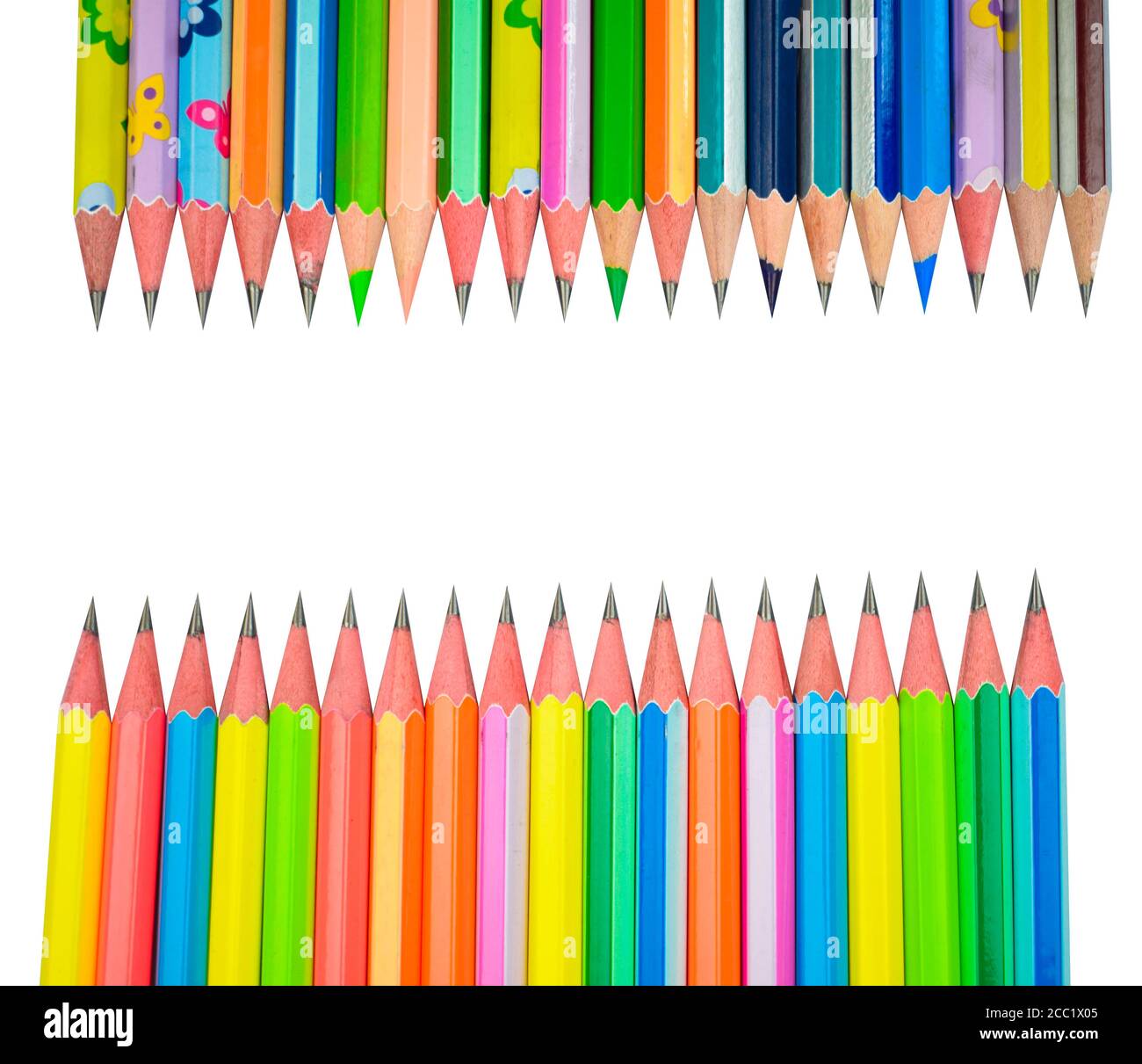 Two row of different colored wood pencil crayons facing each other on ...