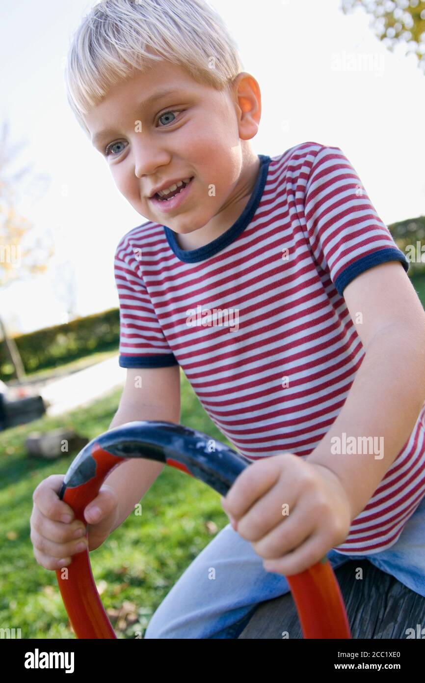 Little boy (4-5) playing on playground Stock Photo - Alamy