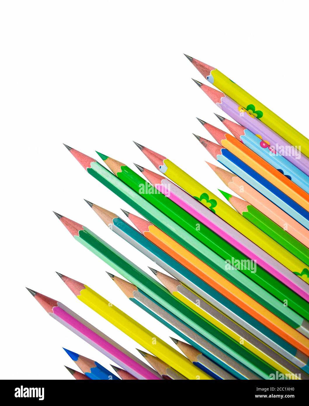 A long line of many different colored wood pencil crayons a white paper ...