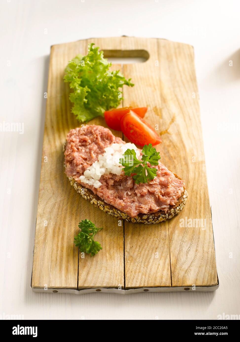 Slice of bread with minced meat on chopping board hi-res stock ...
