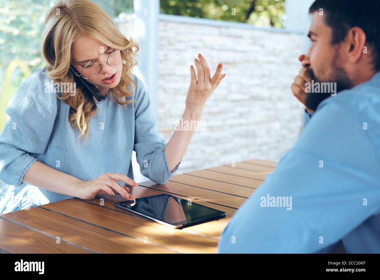 Man and woman outdoors work colleagues communicating phone teamwork ...