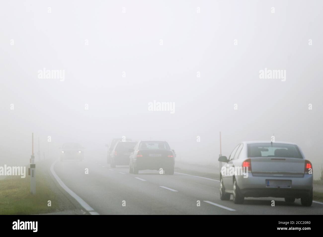 Traffic on road in mist Stock Photo - Alamy
