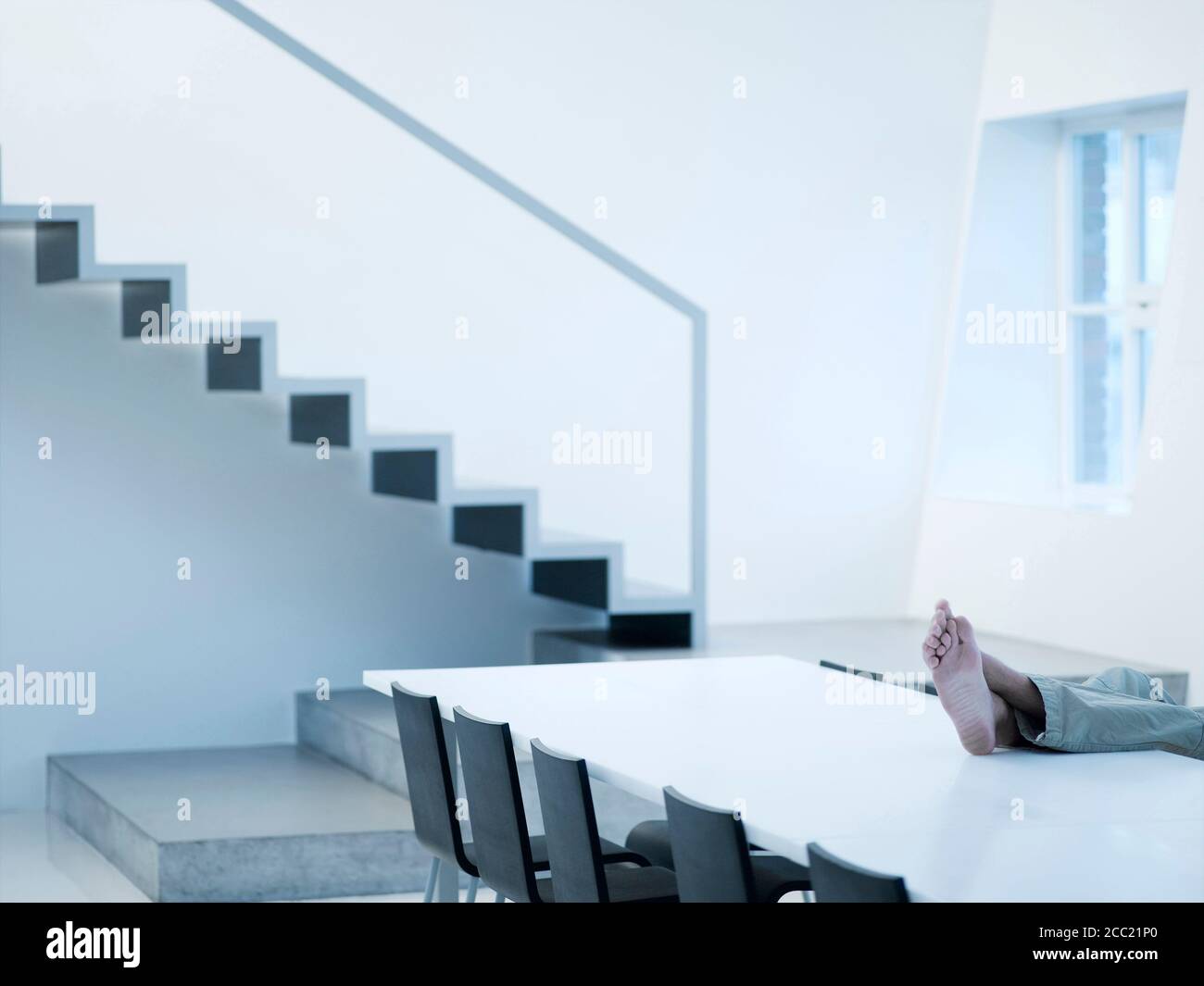Person relaxing with feet up on table, side view Stock Photo - Alamy
