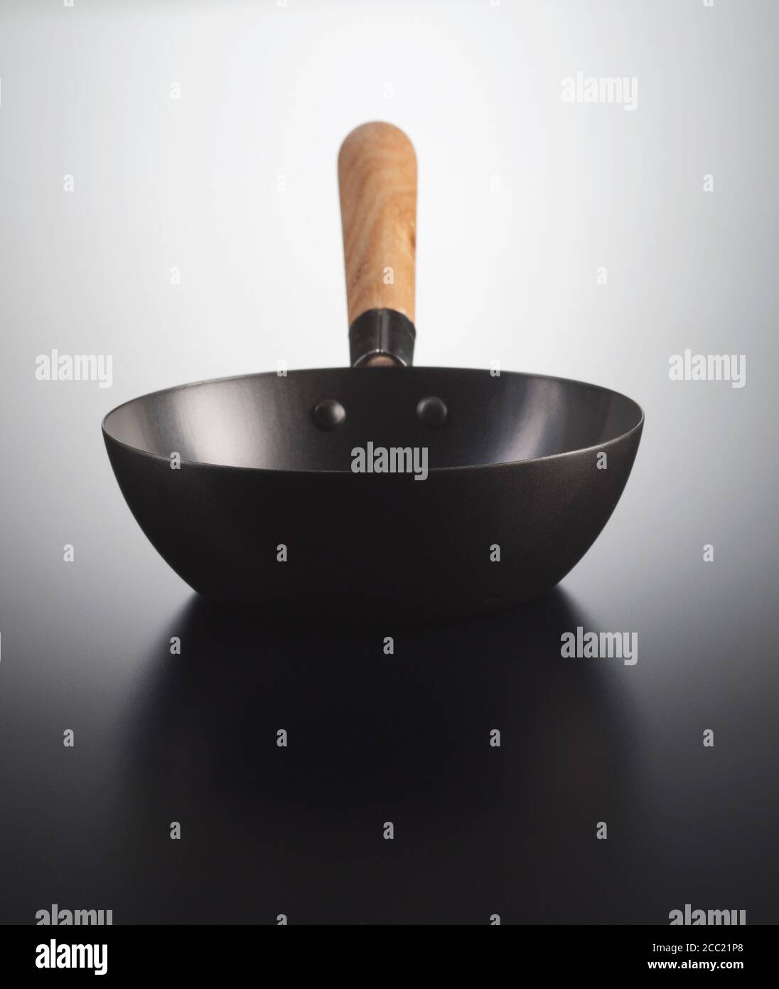 Wok pan on coloured background, close up Stock Photo - Alamy