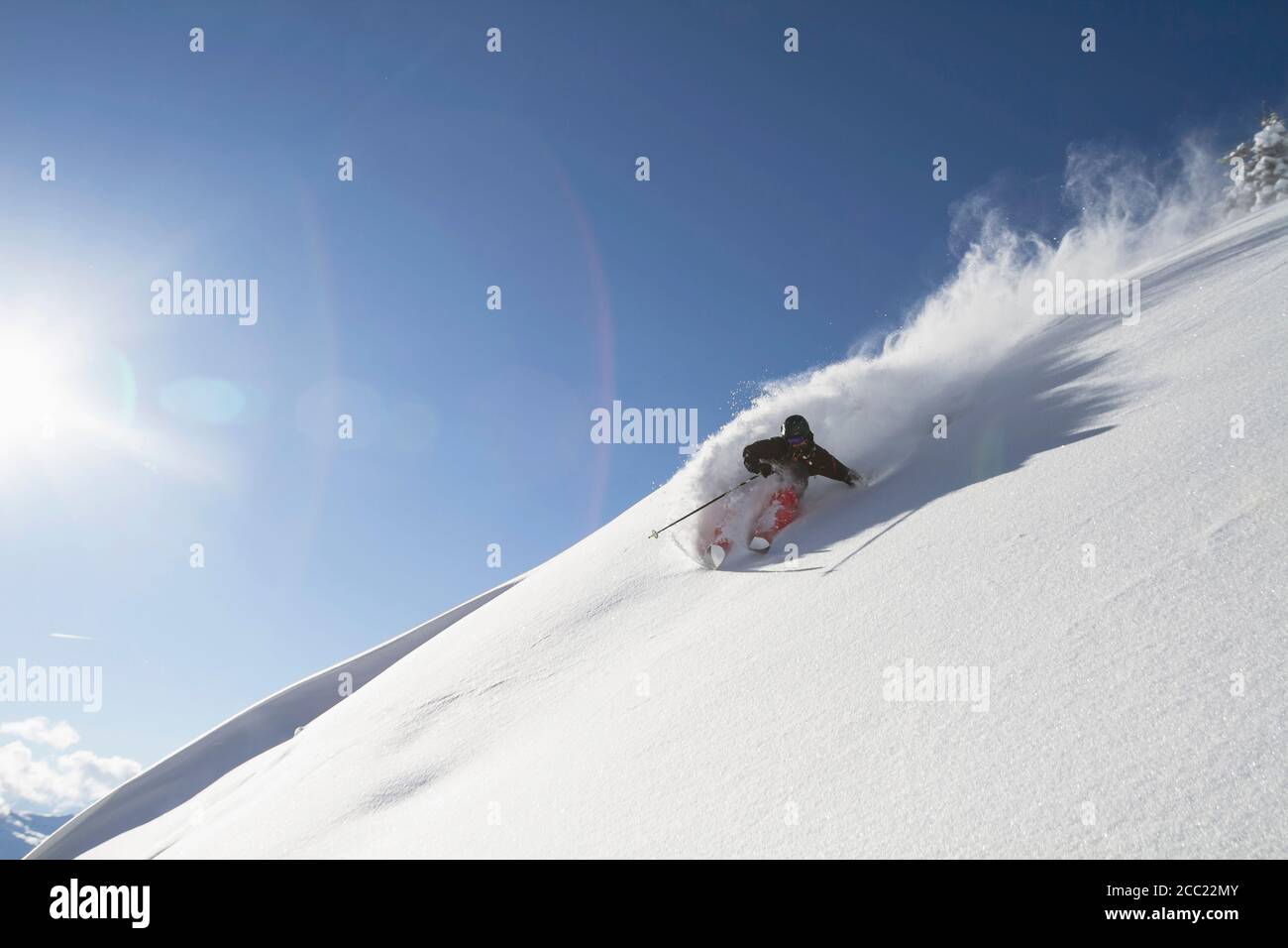 Austria, Tyrol, Mid adult man skiing in snow at Kitzbuehel Stock Photo ...