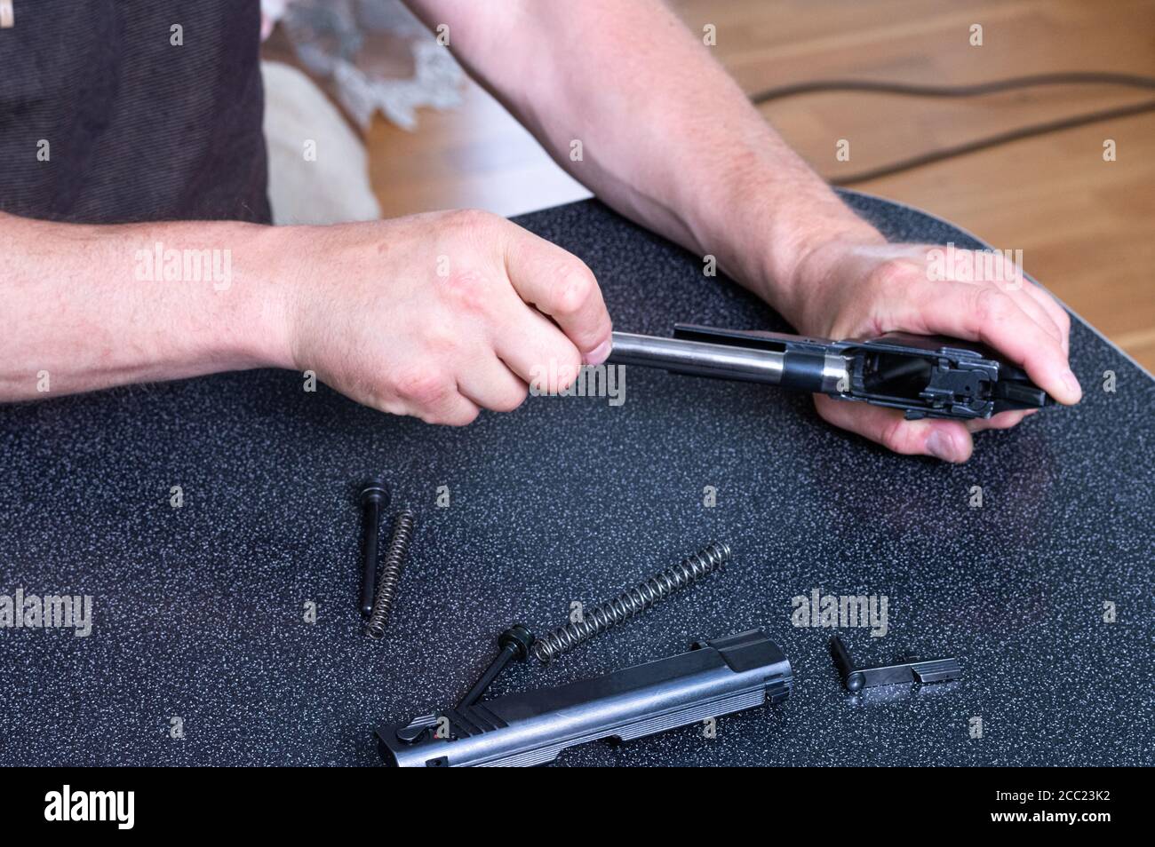 Cleaning the barrel of the pistol. Weapon care. Top Stock Photo - Alamy