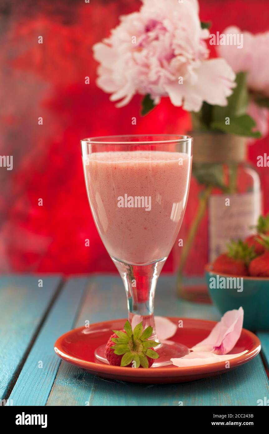Glass of strawberry shake with flowers, close up Stock Photo - Alamy