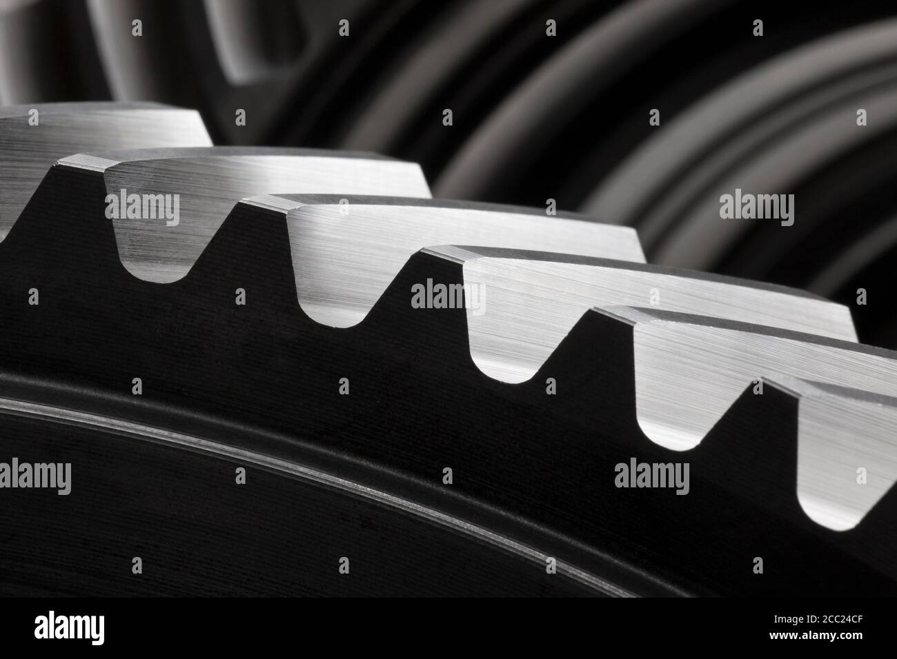 Details of cog wheels in a machinery in dark grey with blurred ...