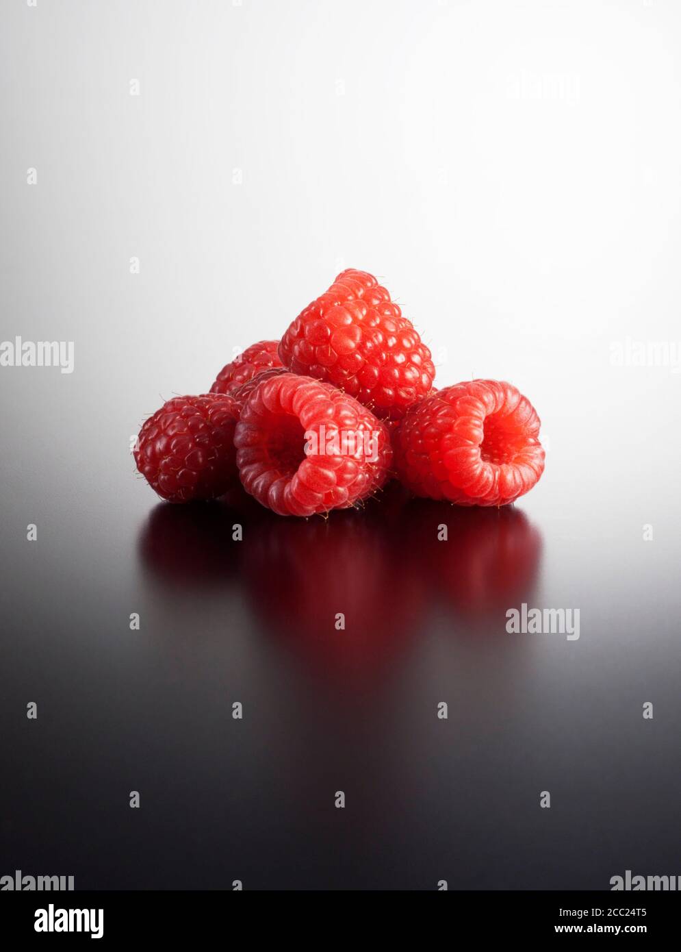 Raspberries on coloured background hi-res stock photography and images ...