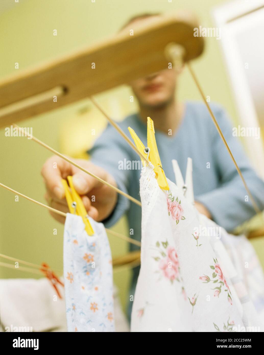 Man hanging up laundry hi-res stock photography and images - Alamy