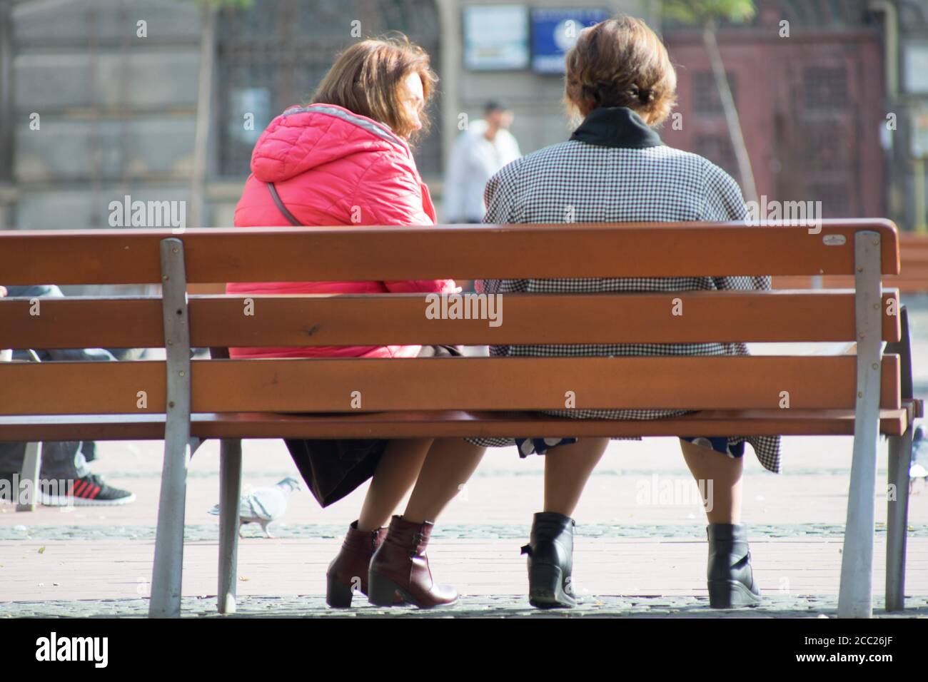 Two women sitting on a bench hi-res stock photography and images - Alamy