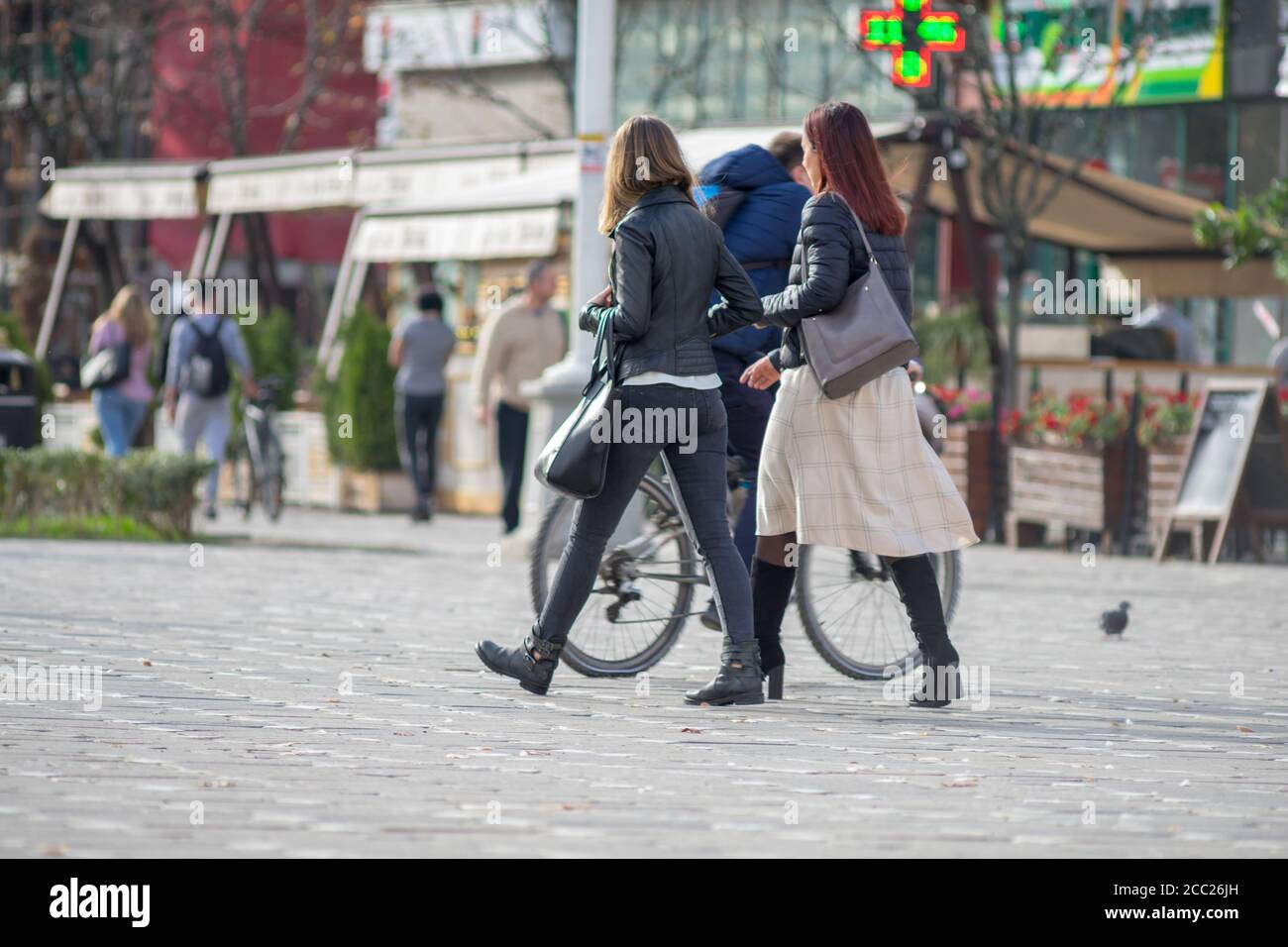 Two women walking and street hi-res stock photography and images - Alamy