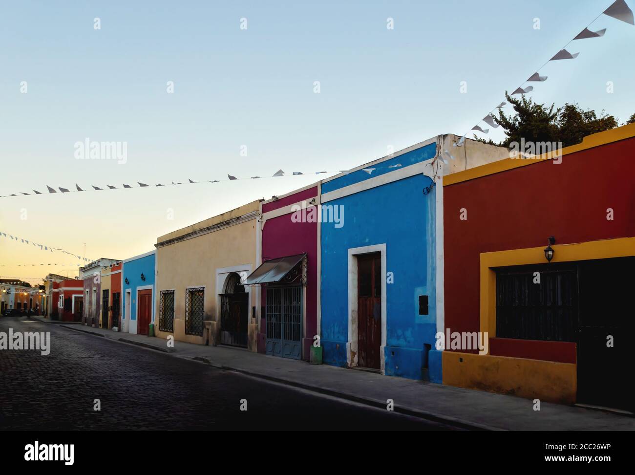 Traditional domnestic Mexican street with colorful colonial buildings ...