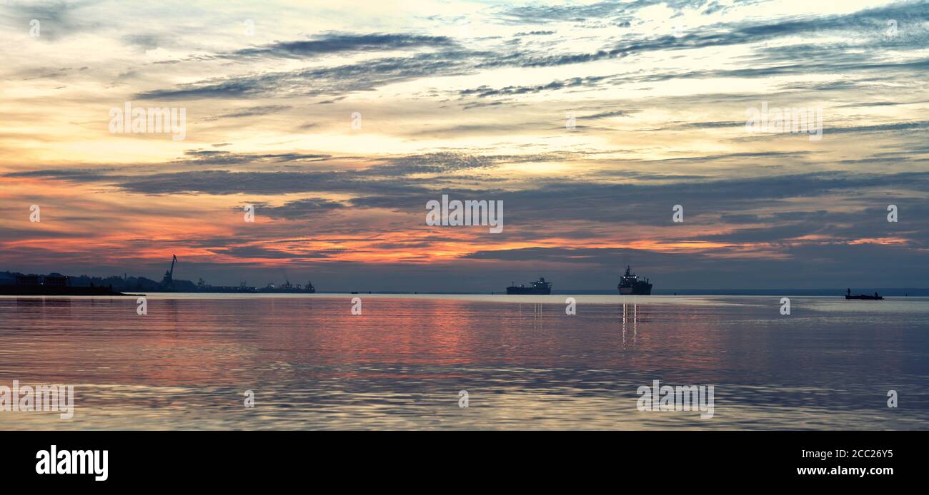 Mesmerizing view of a dramatic sunset sky over the calm sea Stock Photo ...